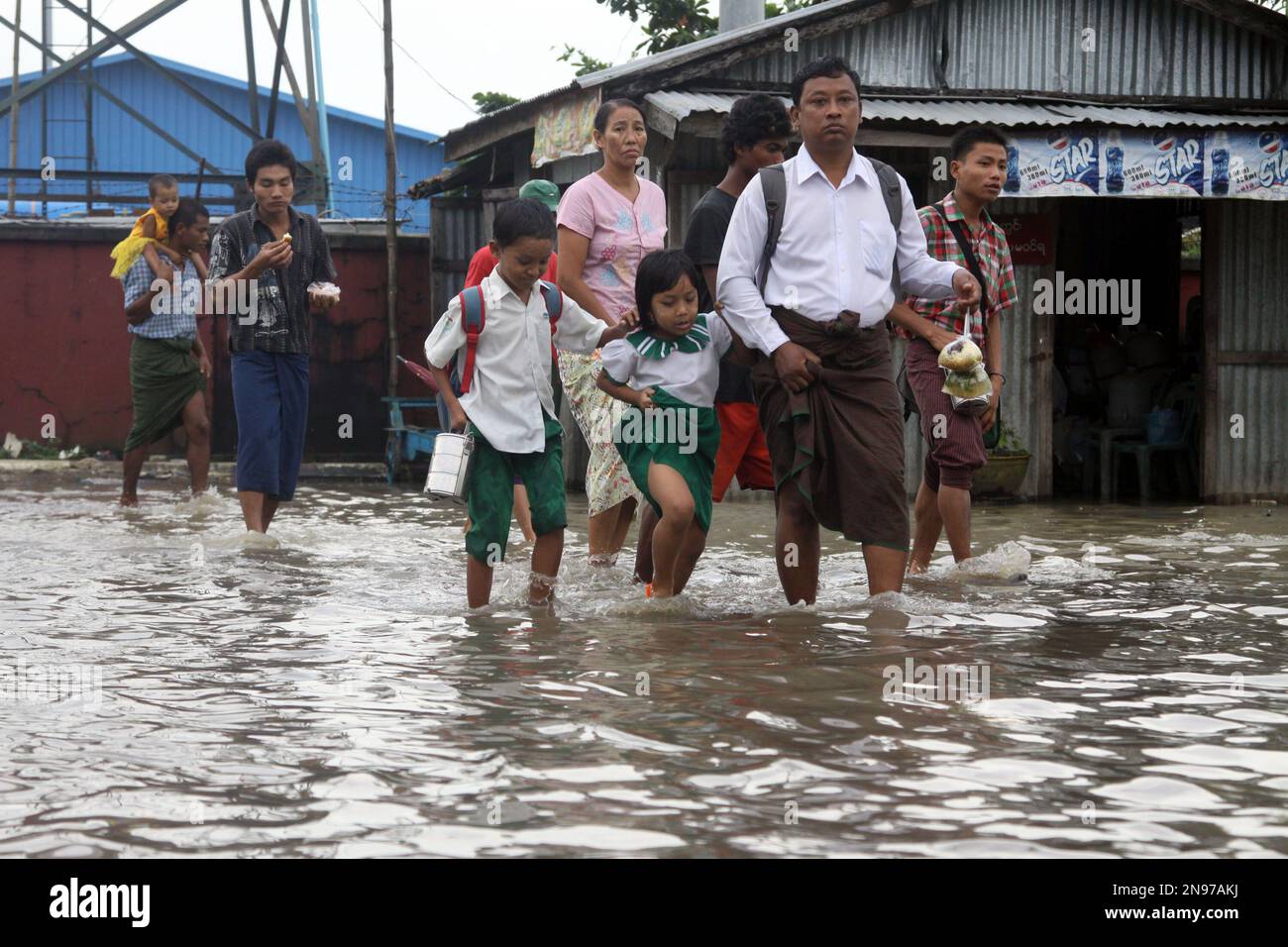 In this photo taken on Monday, Aug.20, 2012, people walk through a ...