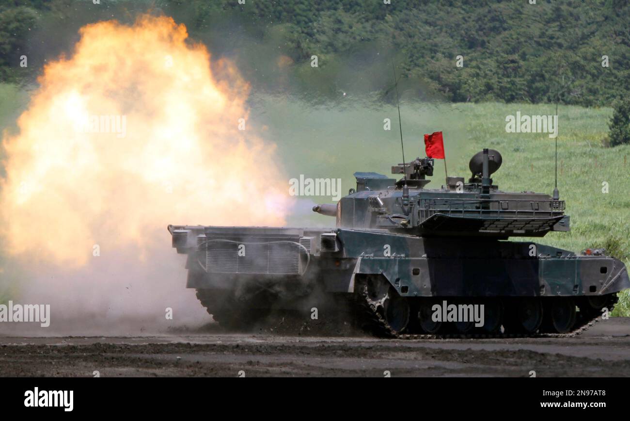 A Japan Ground Self-Defense Force Type 90 tank fires its gun at a ...