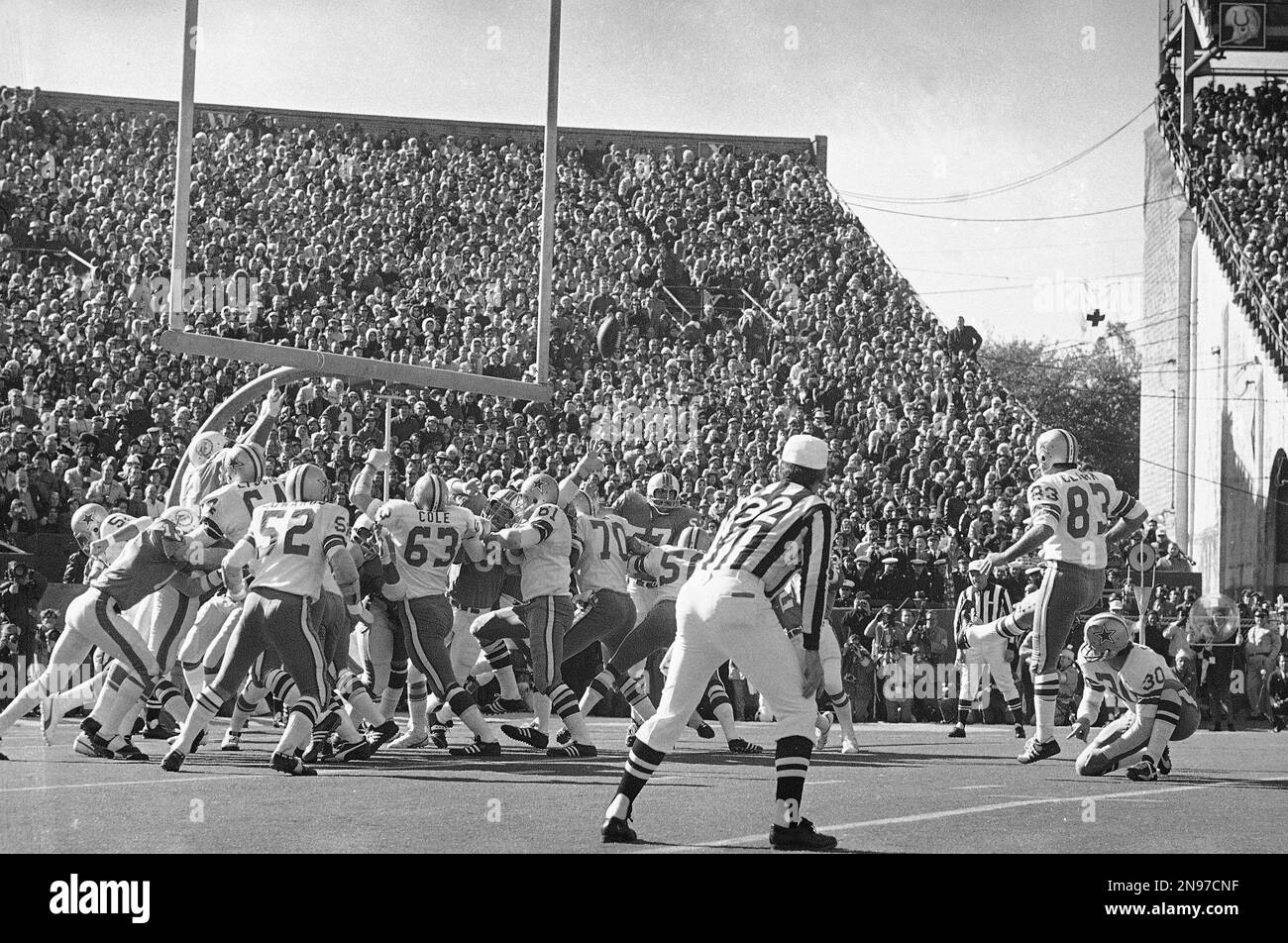 Dallas field goal kicker Mike Clark gets his foot into the ball being ...
