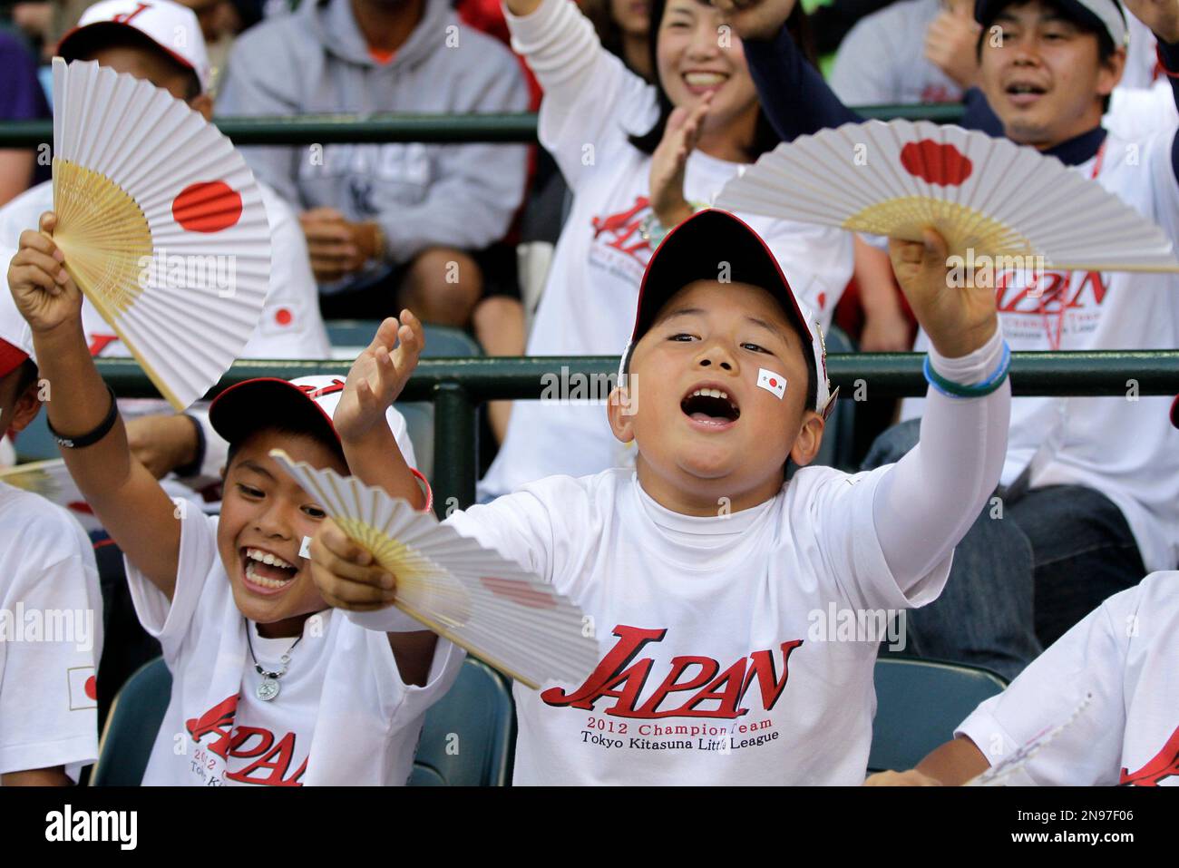Fans of the Tokyo Little League team celebrate after a 2-0 nine inning ...