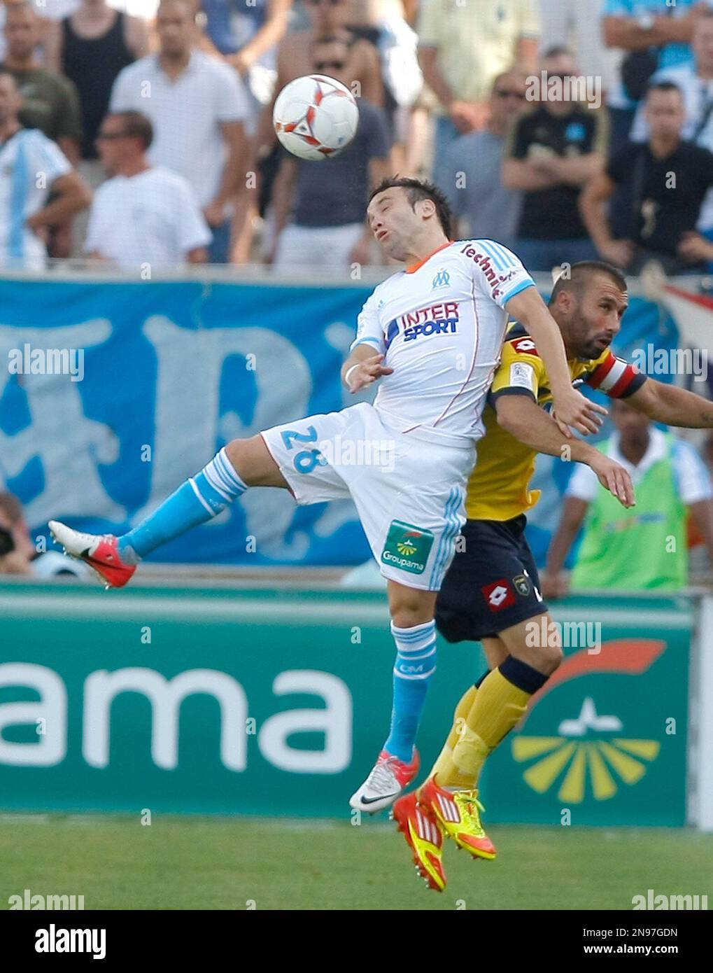 Marseille's French midfielder Mathieu Valbuena, left, challenges for ...