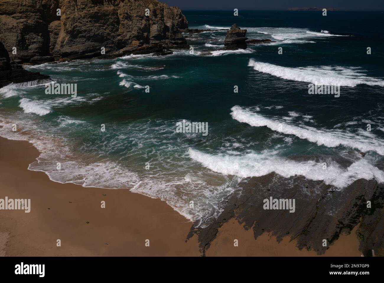 Atlantic waves line up to break in a sandy cove on the rugged Cabo ...
