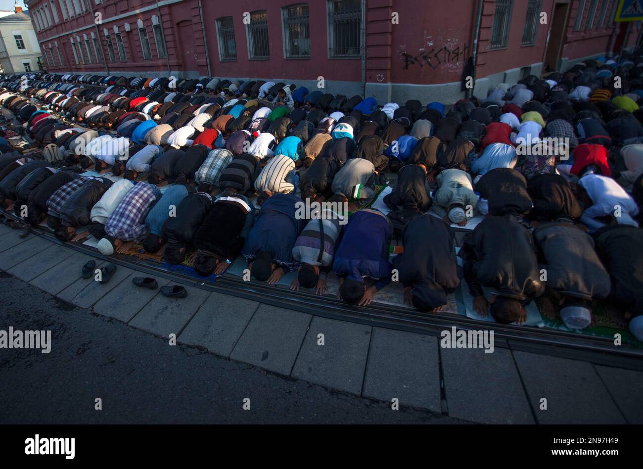 Muslim men, bowing toward Mecca, perform Eid al-Fitr prayers that mark ...
