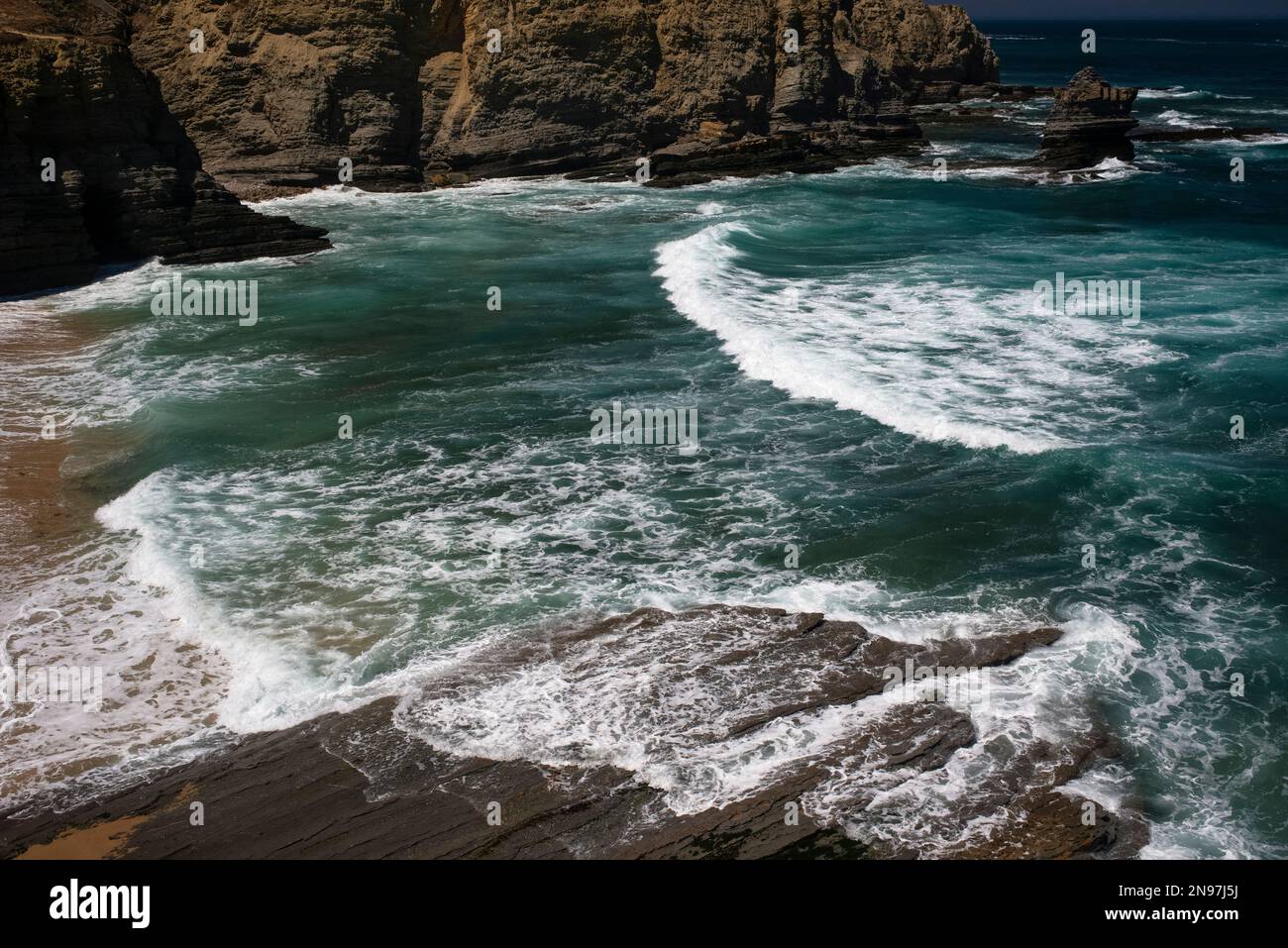 Green water, a sea pillar and a sandy beach: surging Atlantic waves ...