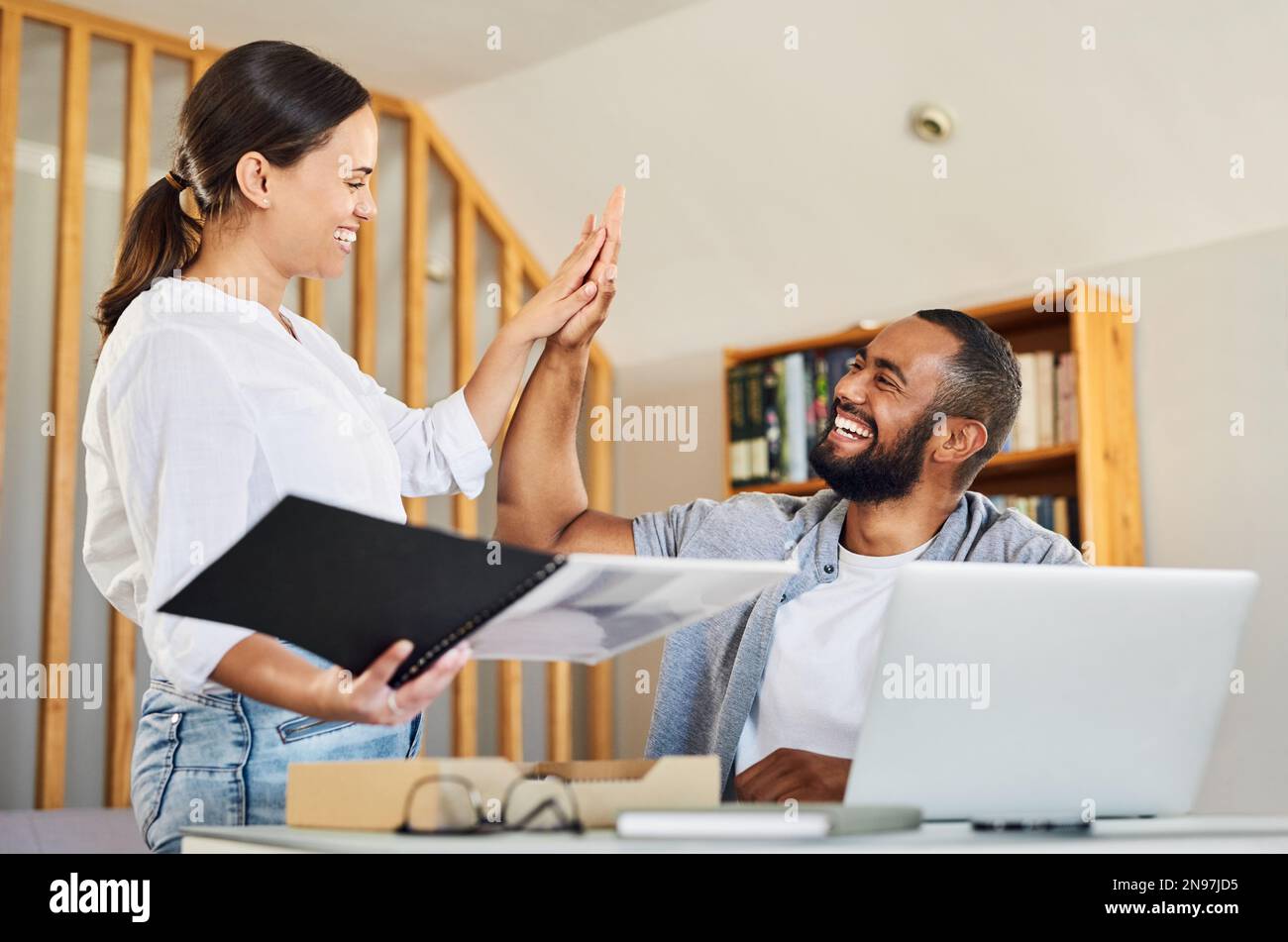 Two people high fiving after success hi-res stock photography and ...