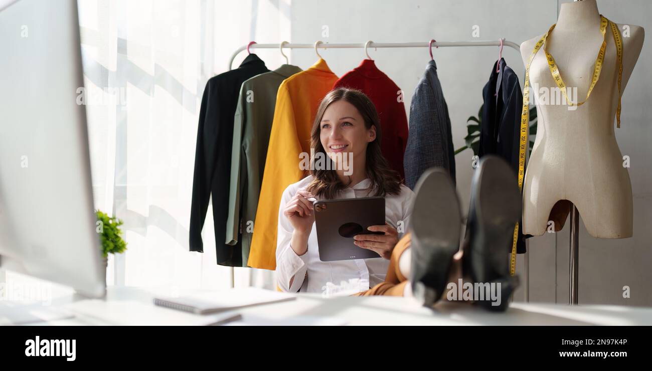 Beautiful young professional stylist working at design studio interior ...