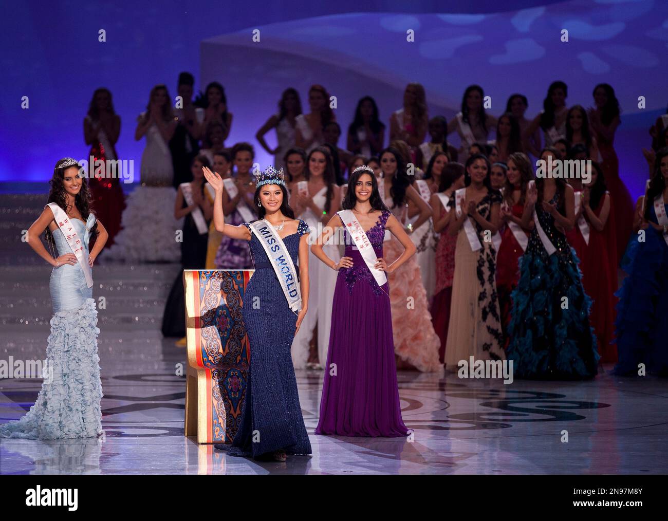 Newly crowned Miss World Yu Wenxia of China, center, waves, flanked by ...