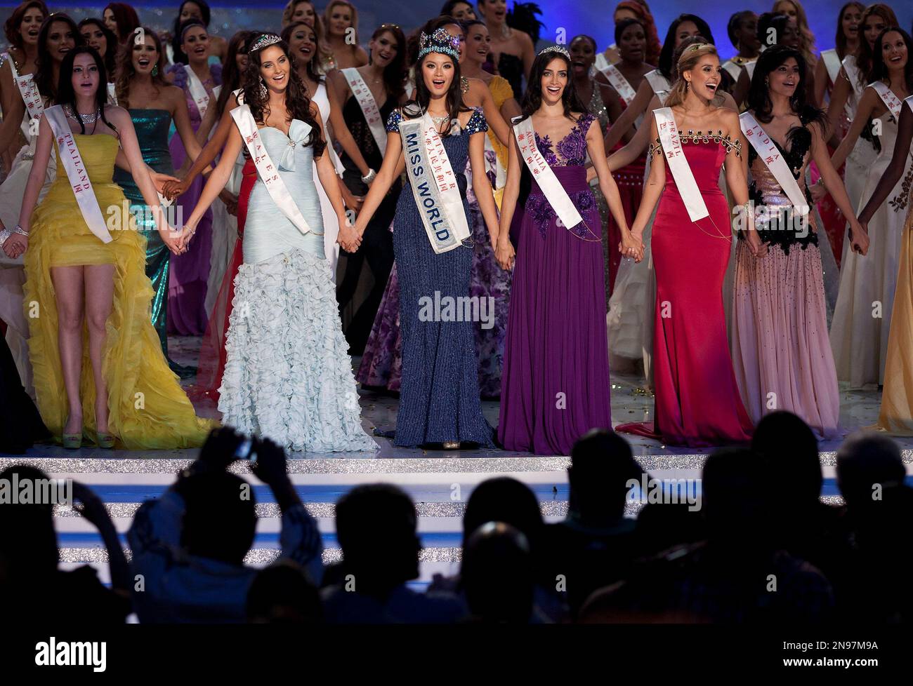 Newly crowned Miss World Yu Wenxia of China, center, holds hand with ...