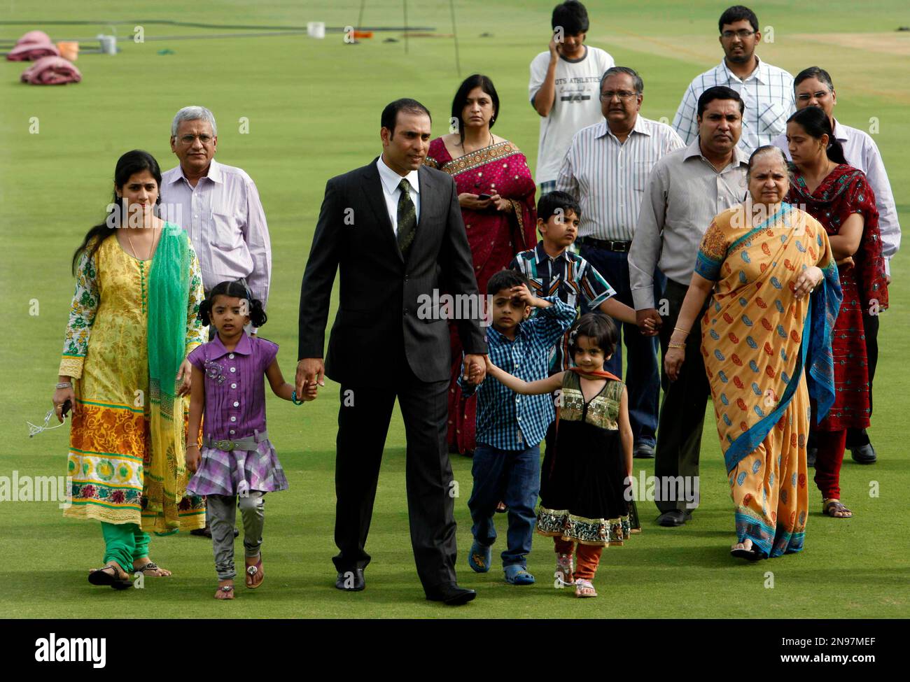 Indian cricketer V.V.S. Laxman, centre, arrives with his family to ...