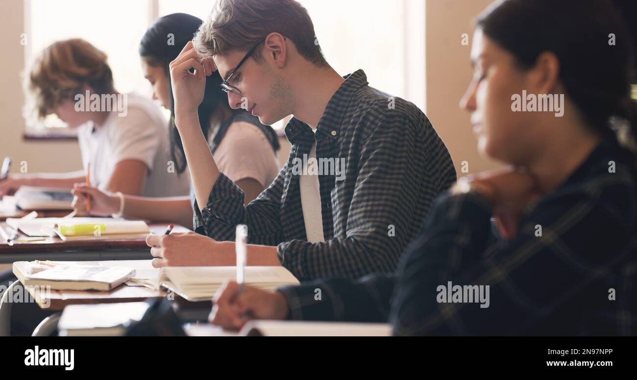 Study hard, make a difference. teenagers writing an exam in a classroom ...