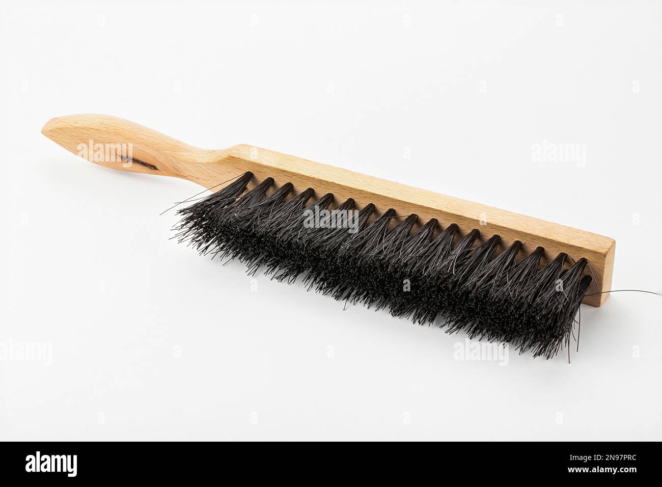 Brush for cleaning the surface with a wooden handle on a white ...