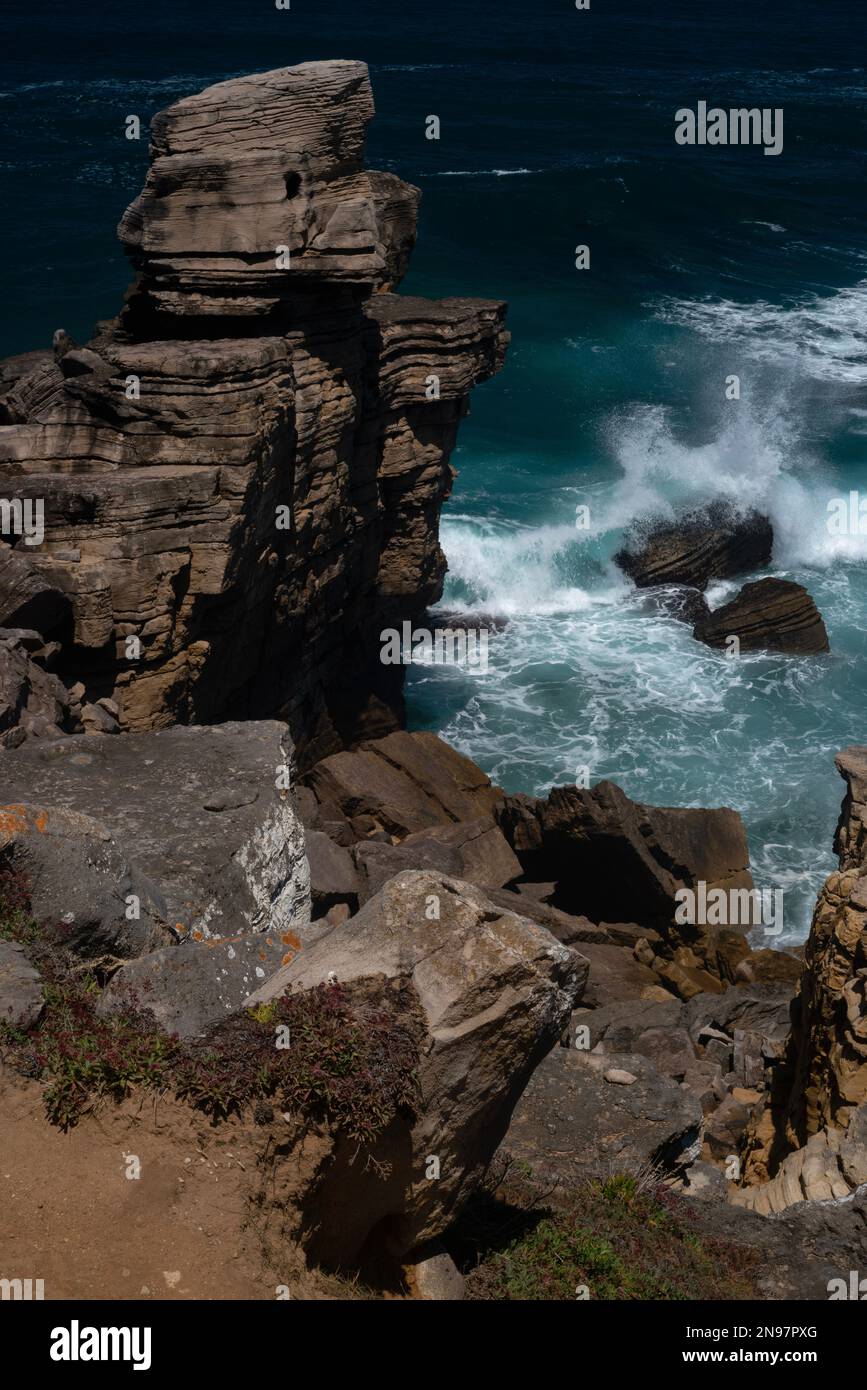 A breaking wave sends Atlantic surf high into the air below a ...