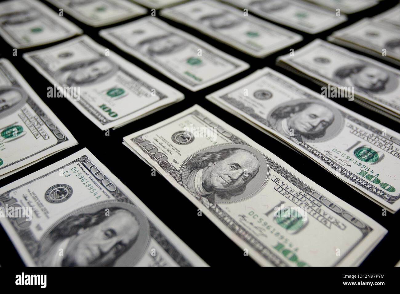Alleged counterfeit 100 U.S. dollar notes sit on display for the press ...