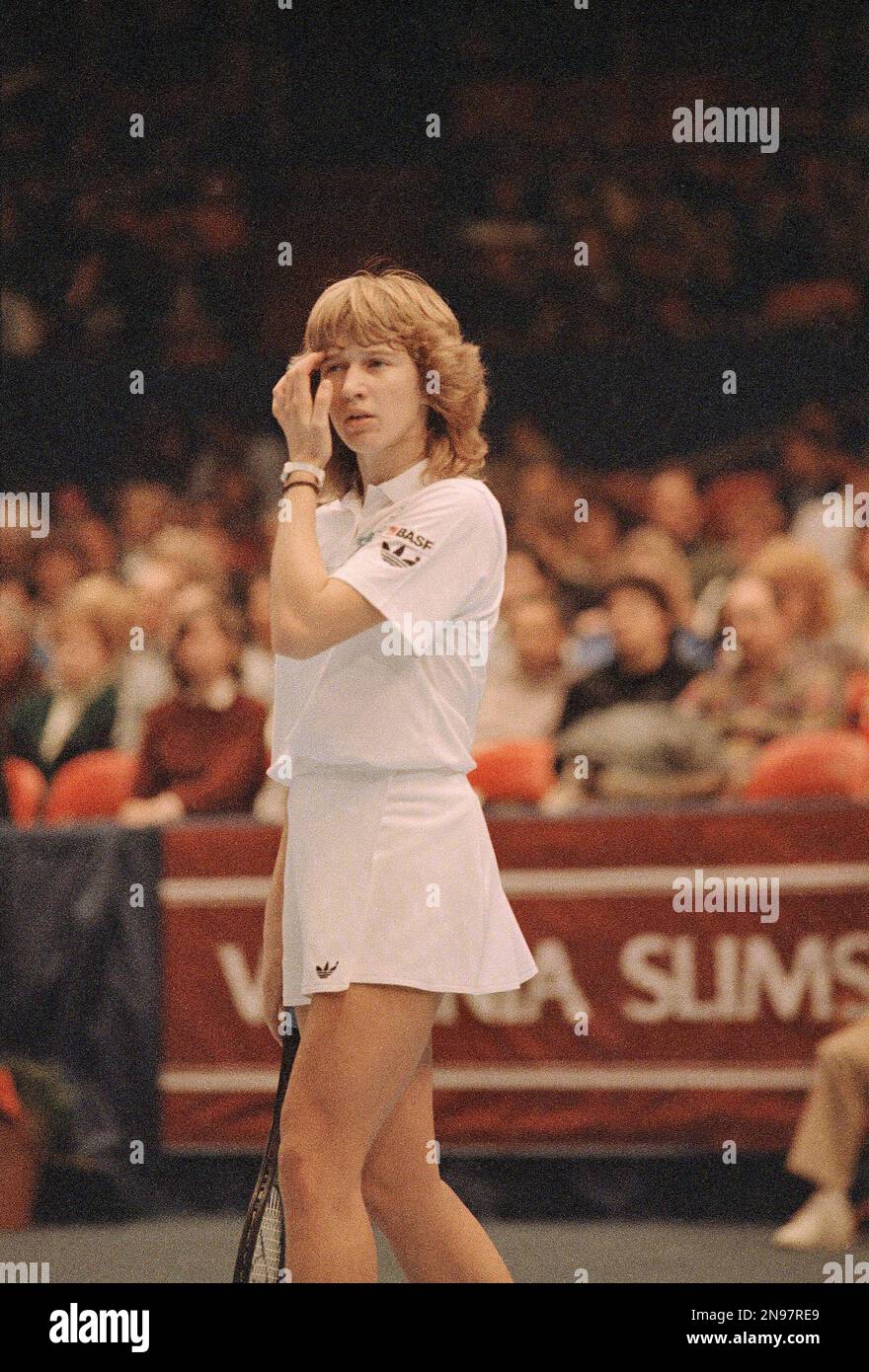 Steffi Graf brushes the hair from her face during a match with Manuela ...