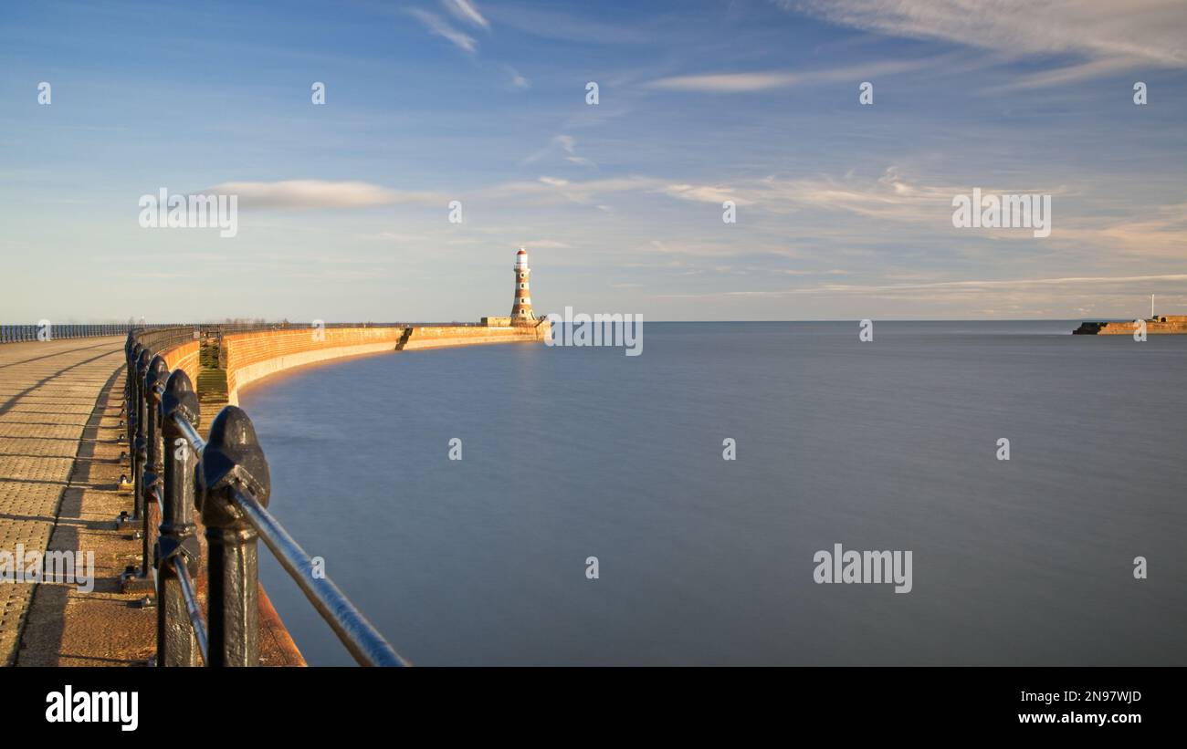 Roker Pier and Lightouse reaches out from the North Sea coast in ...