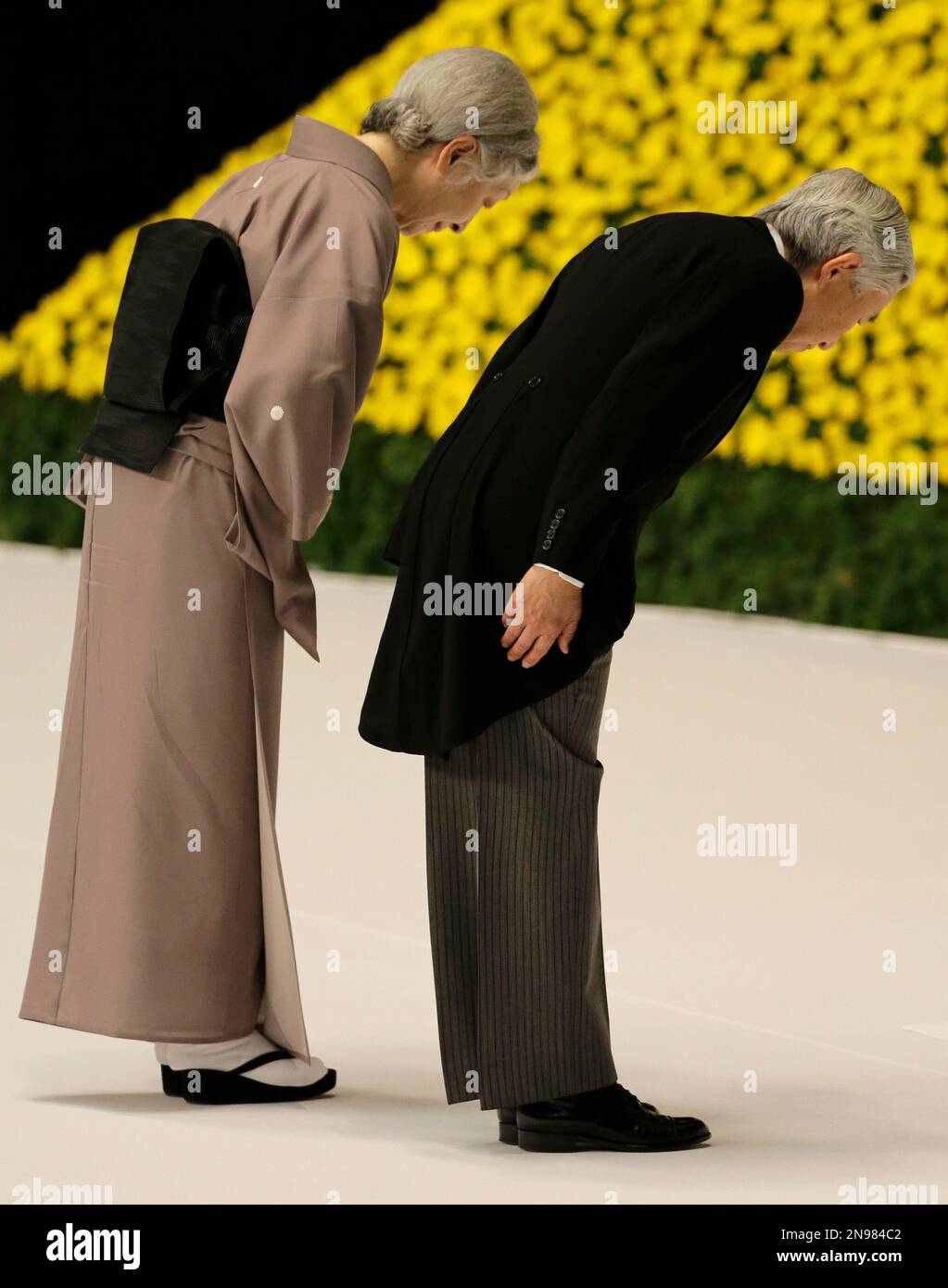 Japan's Emperor Akihito, right, and Empress Michiko bow deeply before ...