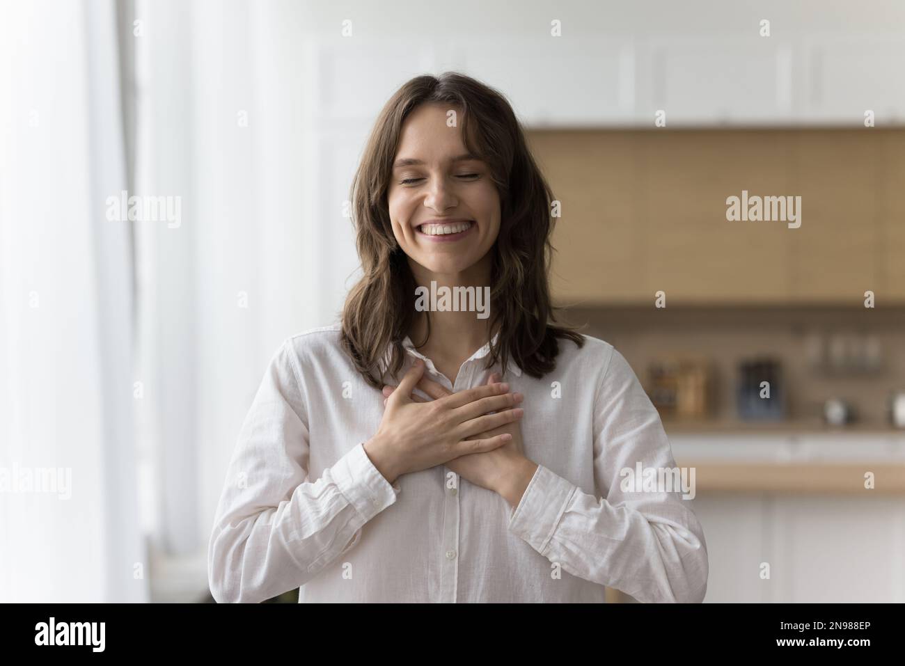 Happy peaceful pretty woman making gesture of gratitude Stock Photo - Alamy