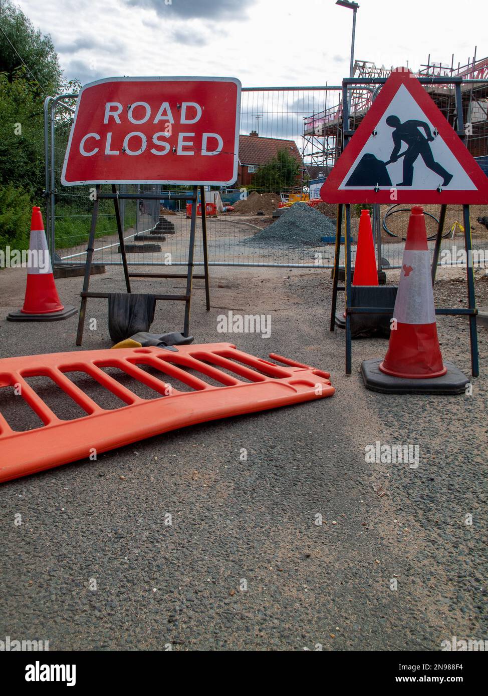 Mess of assorted road signs, traffic cones, metal fencing and a ...