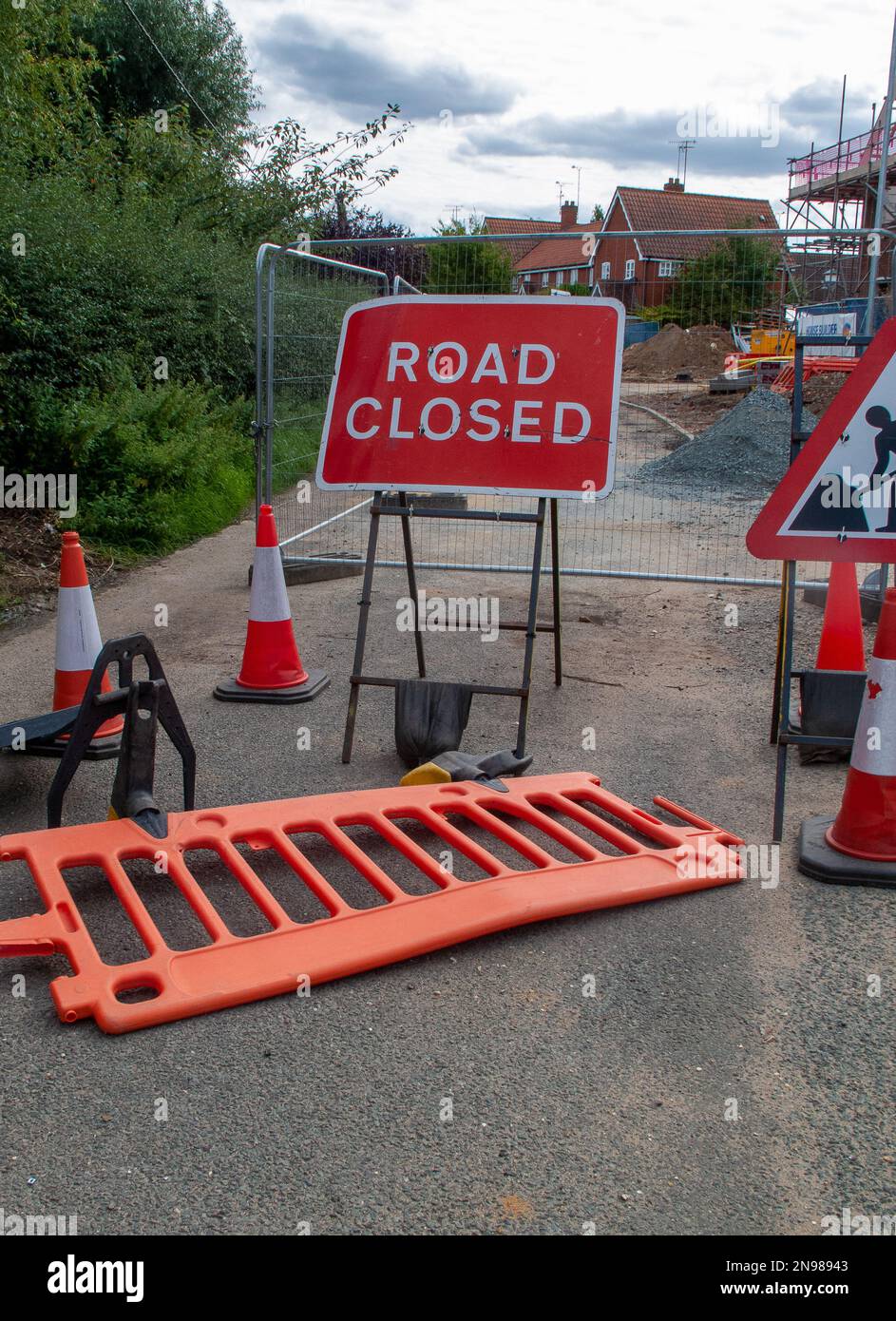 Mess of assorted road signs, traffic cones, metal fencing and a ...