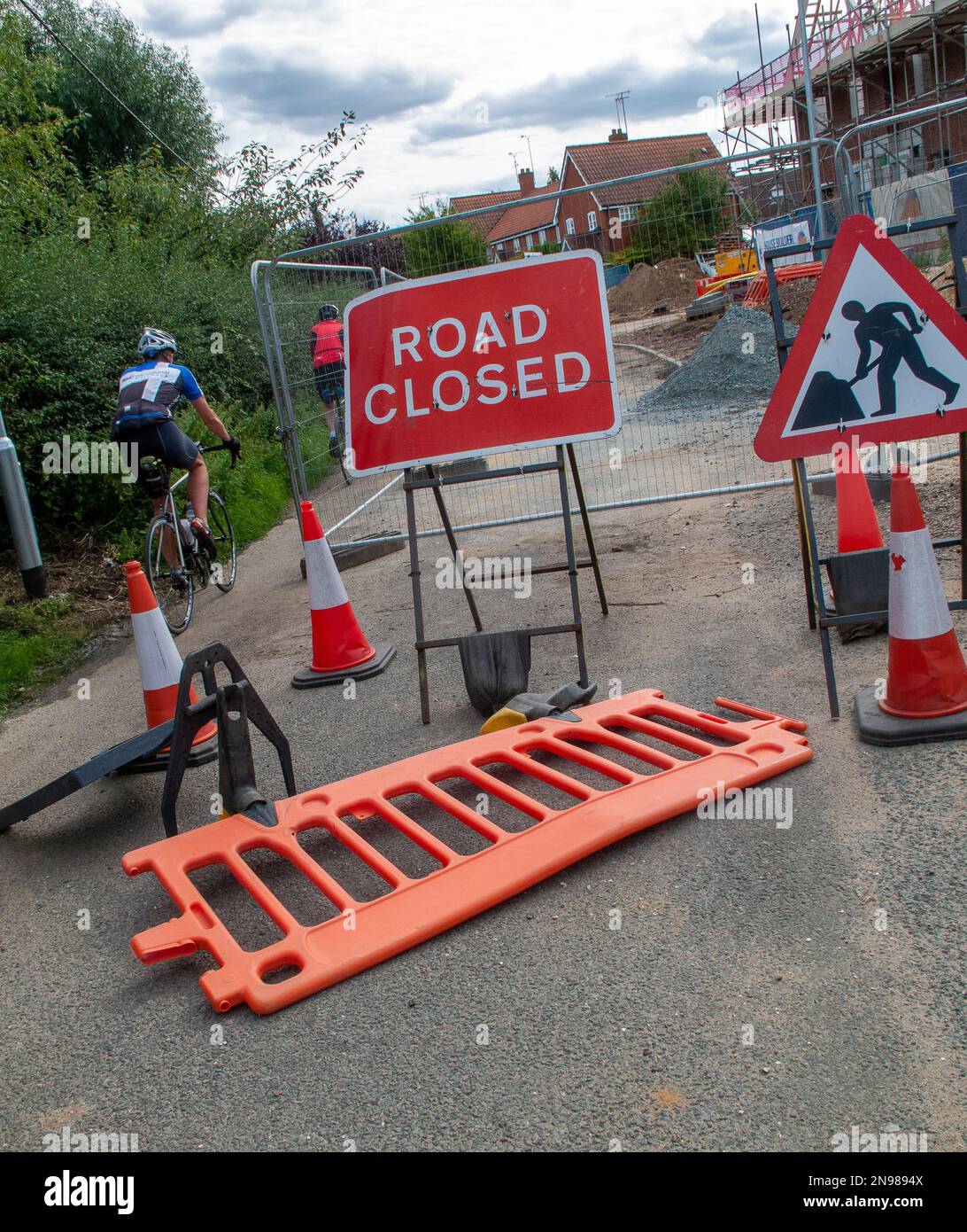 Mess of assorted road signs, traffic cones, metal fencing and a ...