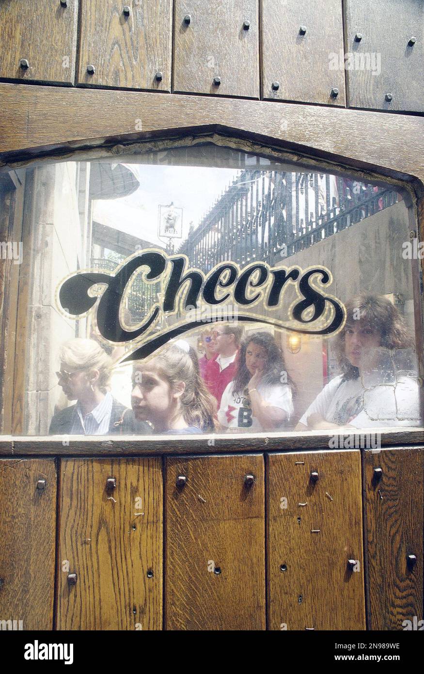 People line up outside the Bull and Finch Pub in Boston at lunchtime as ...