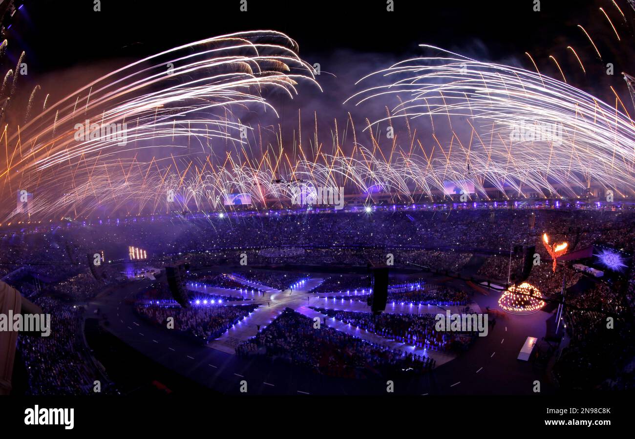 Fireworks soar over the Olympic Stadium as the Olympic flame is lowered ...