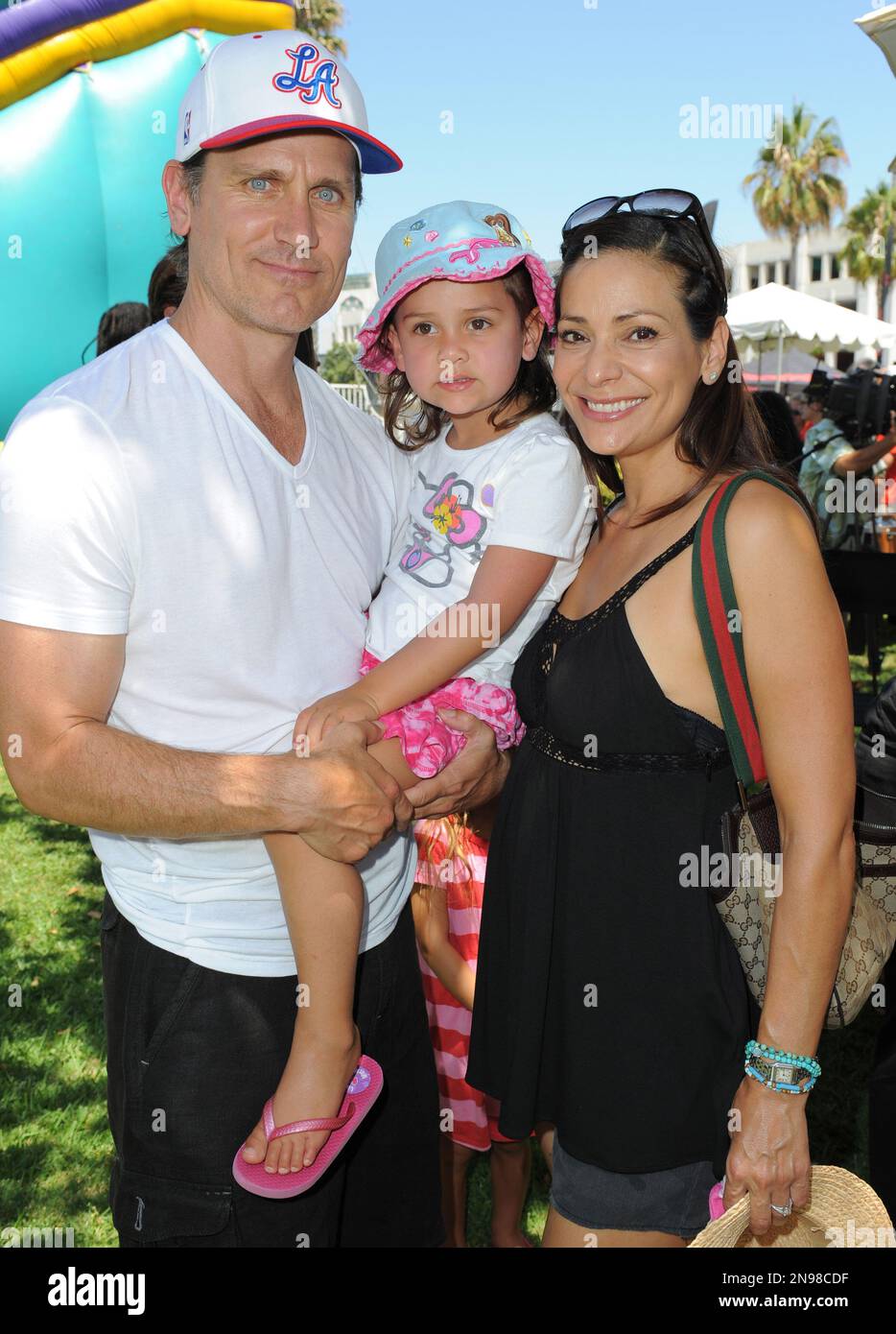 Kent Katich, left, Constance Marie, right, and their daughter attend ...