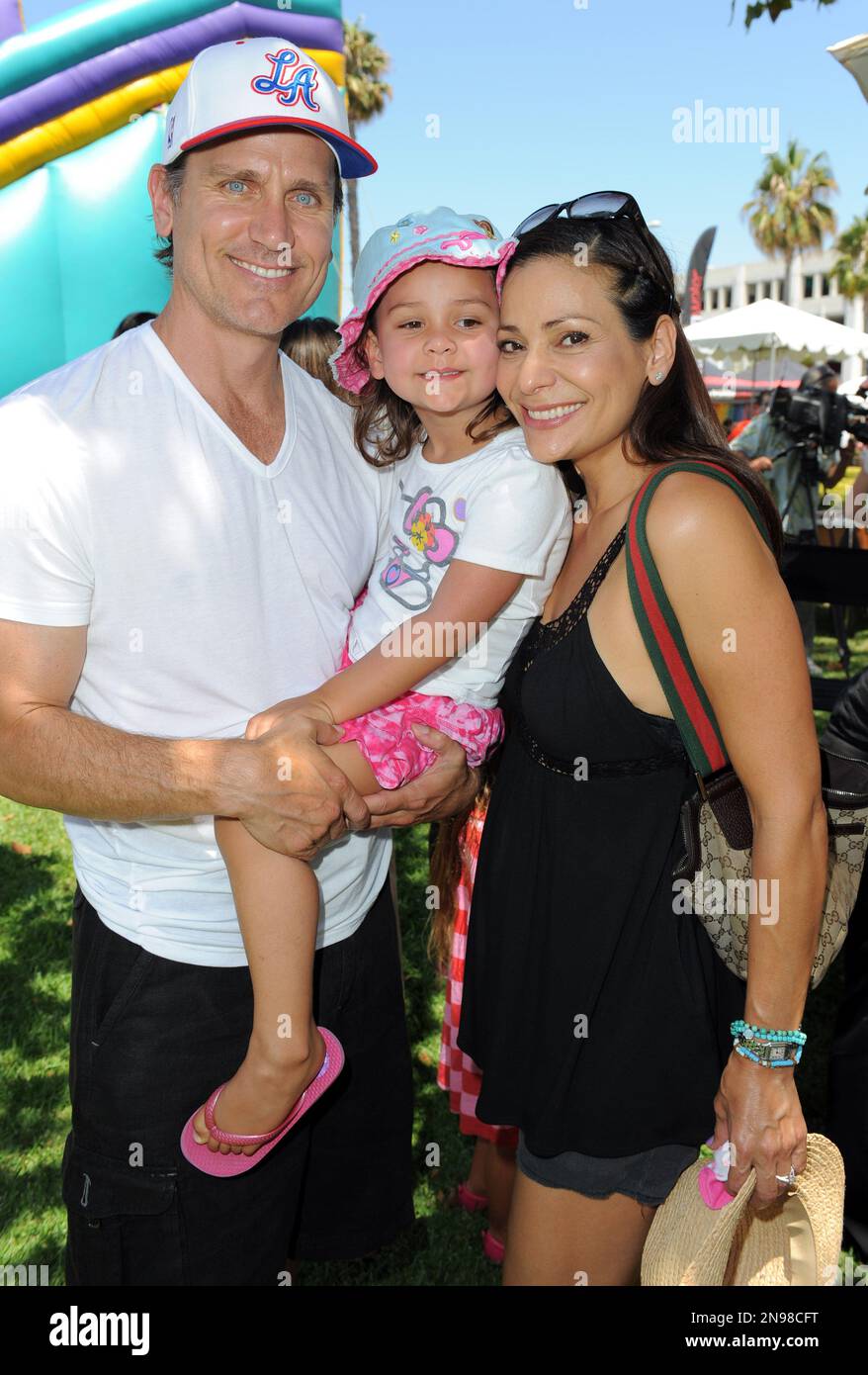 Kent Katich, left, Constance Marie, right, and their daughter attend ...
