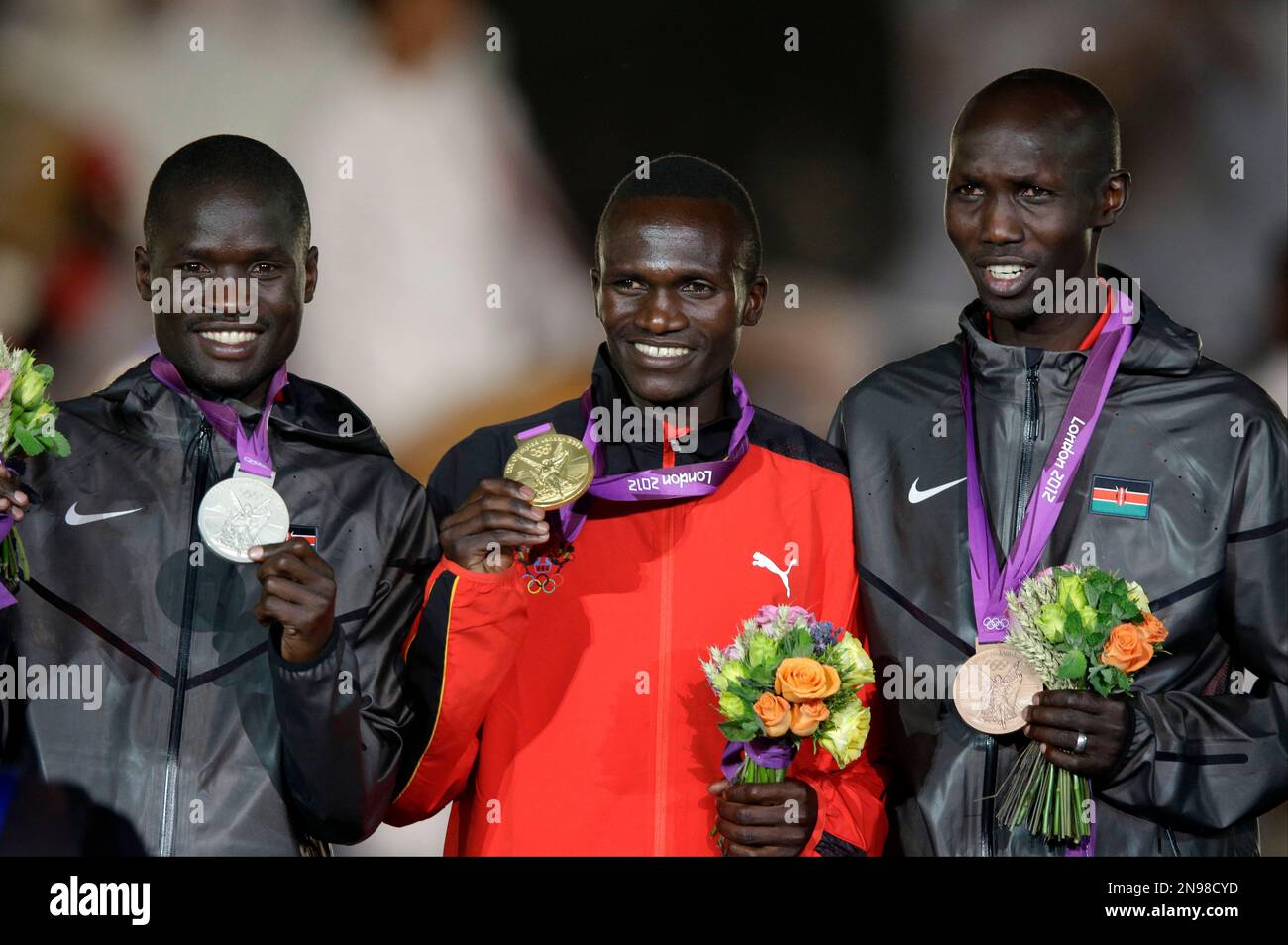Men's marathon gold medalist Uganda's Stephen Kiprotich, center, is ...