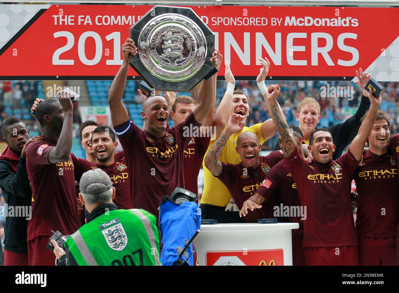 Manchester City's captain Vincent Kompany lifts the trophy after their ...