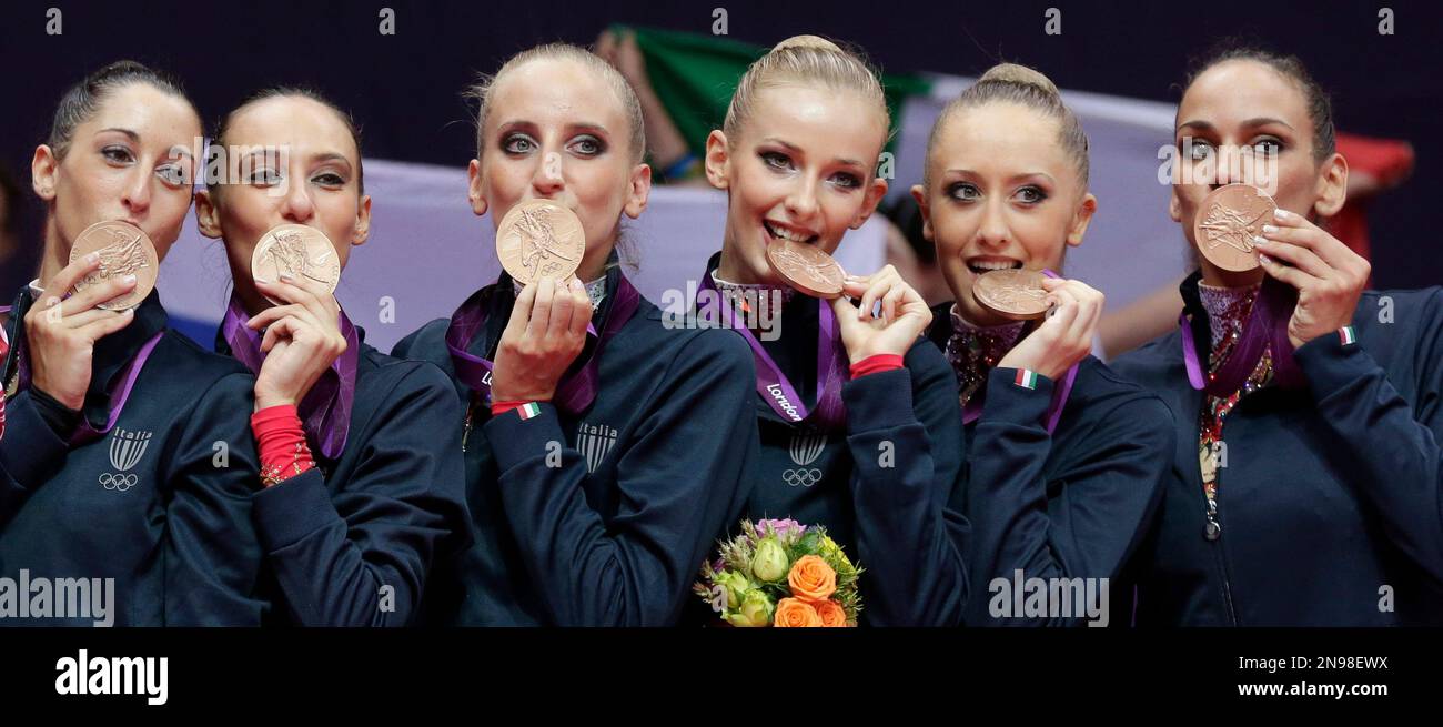 Members of the team from Italy kiss their bronze medals during the ...