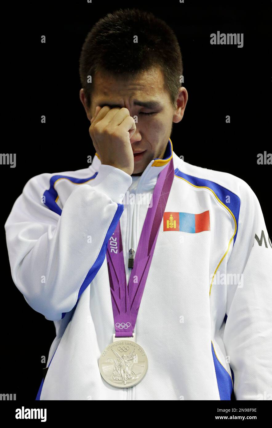 Silver medalist Mongolia's Tugstsogt Nyambayar shows his emotions ...