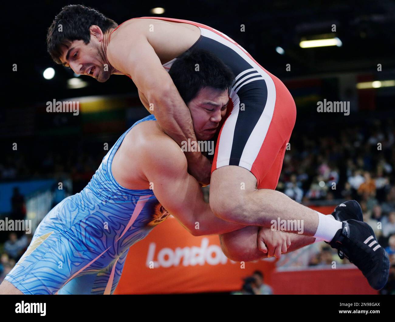 Magomed Musaev of Kyrgyzstan, (in red) and Takao Isokawa of Japan, (in ...