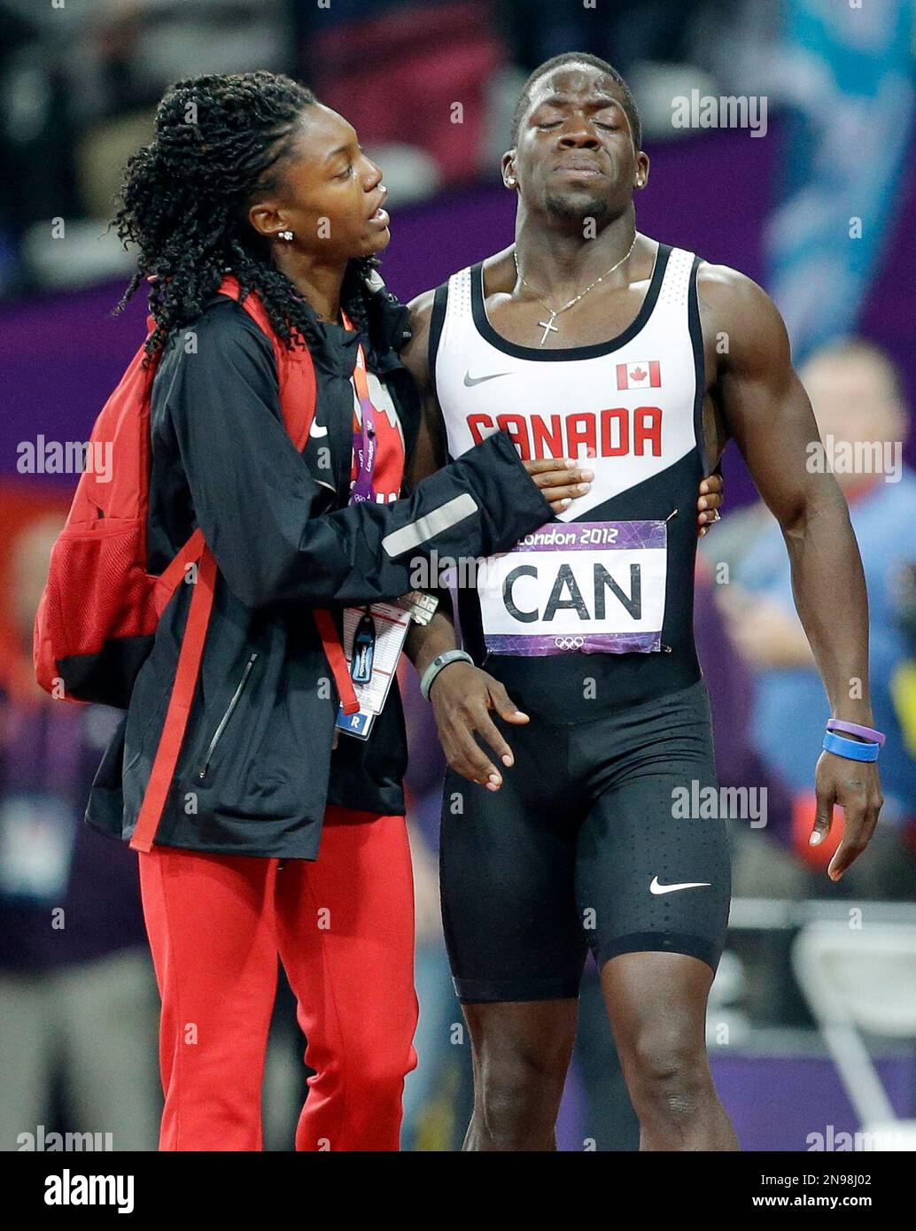 Canada's Justyn Warner, right, is comforted by a friend after his team ...
