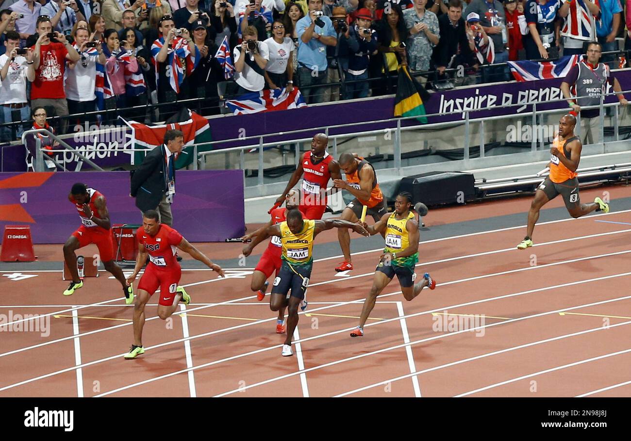 Jamaica's Usain Bolt takes the baton to lead in the men's 4 x 100-meter relay during the ...