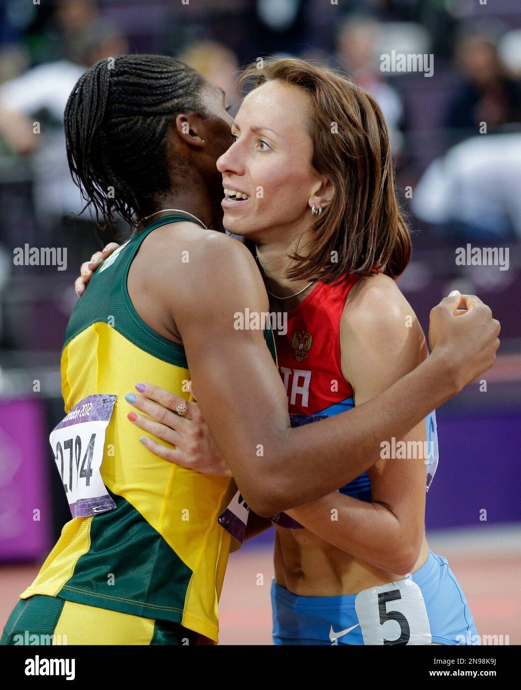 Russia's gold medallist Mariya Savinova, right, is embraced by South ...
