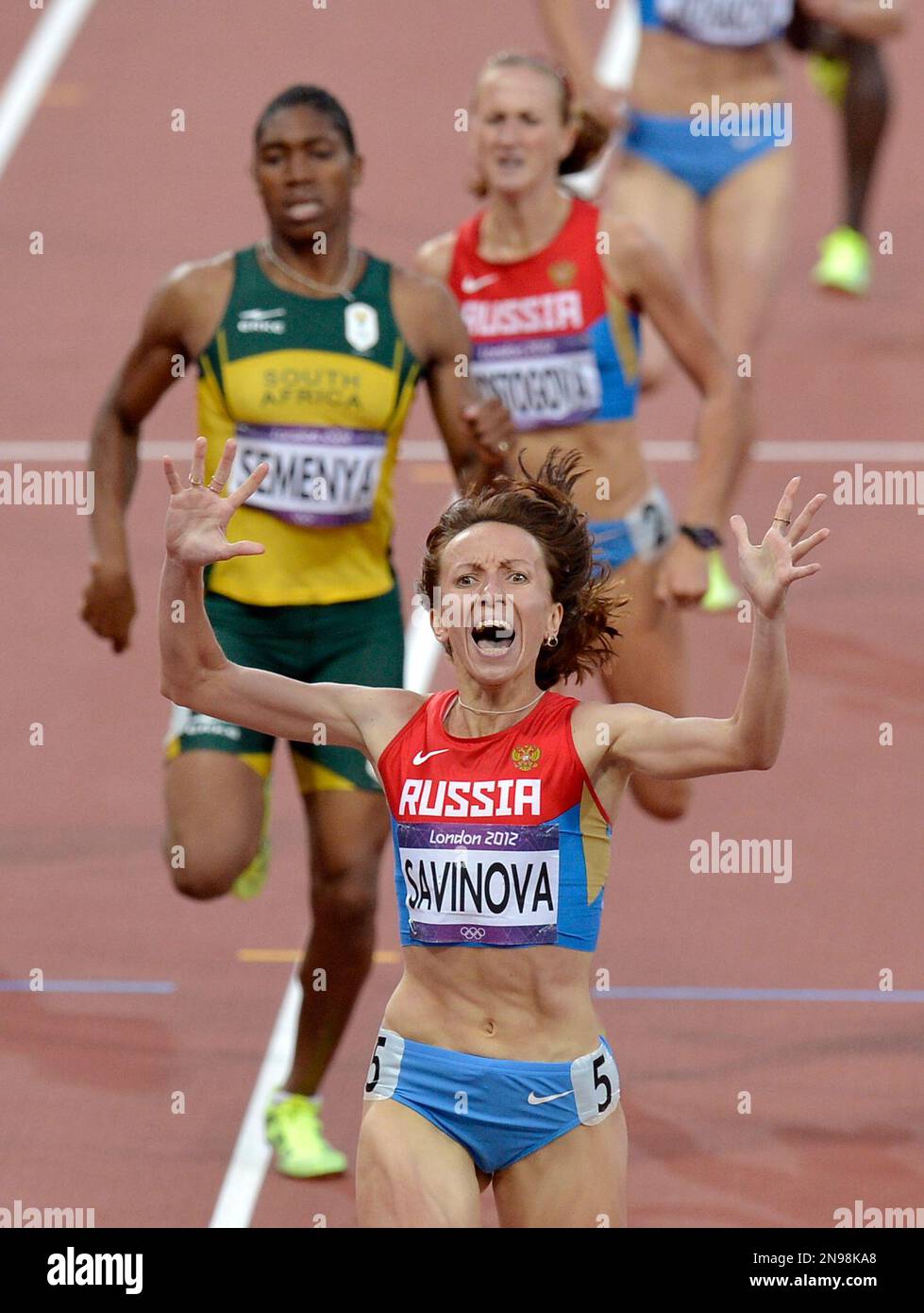Russia's Mariya Savinova celebrates as she crosses the finish line ...