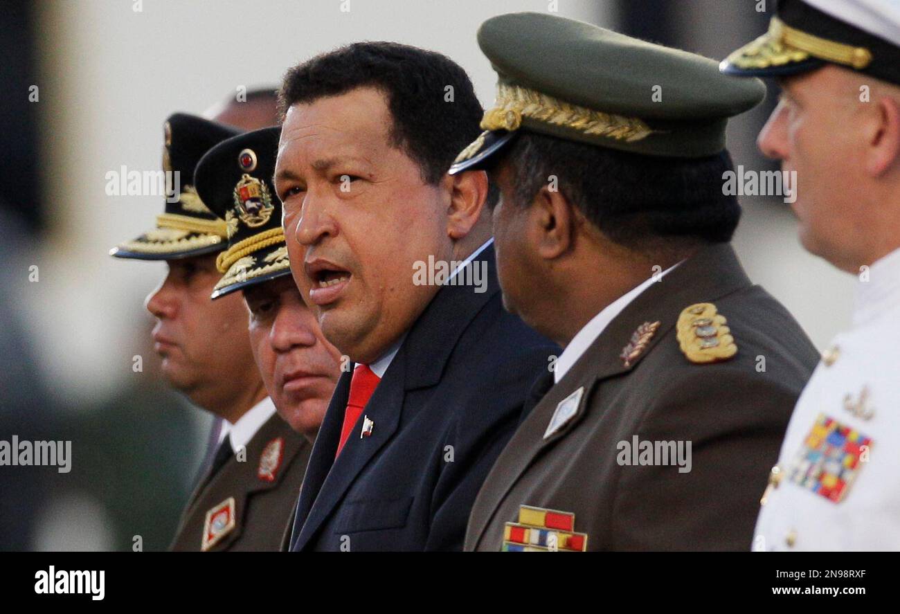 Venezuela's President Hugo Chavez, center, attends a military ceremony ...