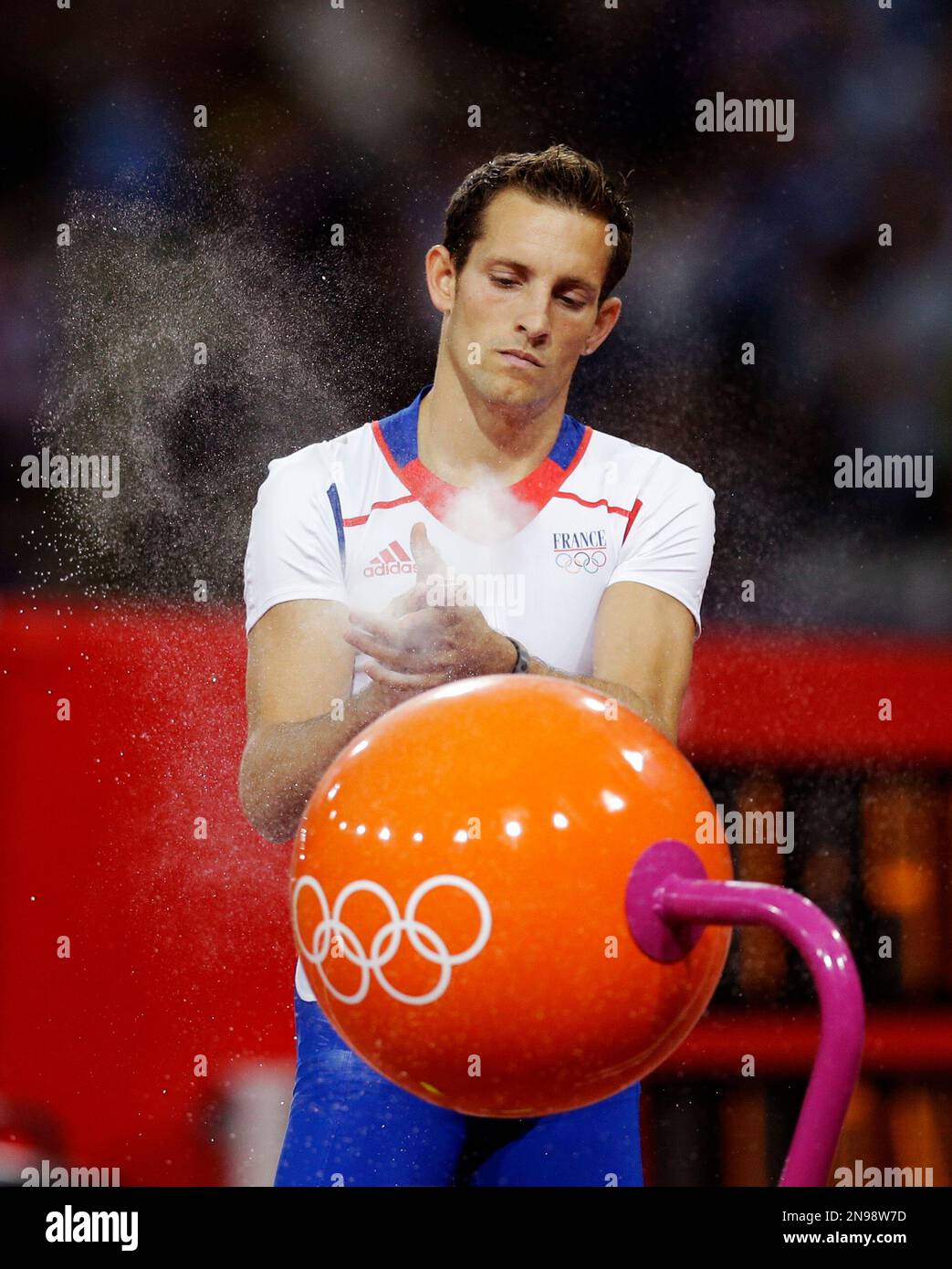 France's Renaud Lavillenie chalks up before taking a jump in the men's ...