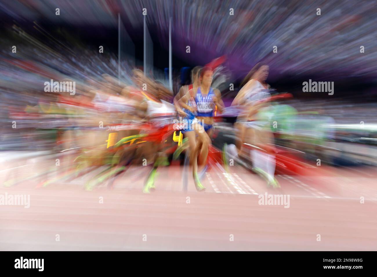 Athletes compete in the women's 5000-meter final during the athletics ...