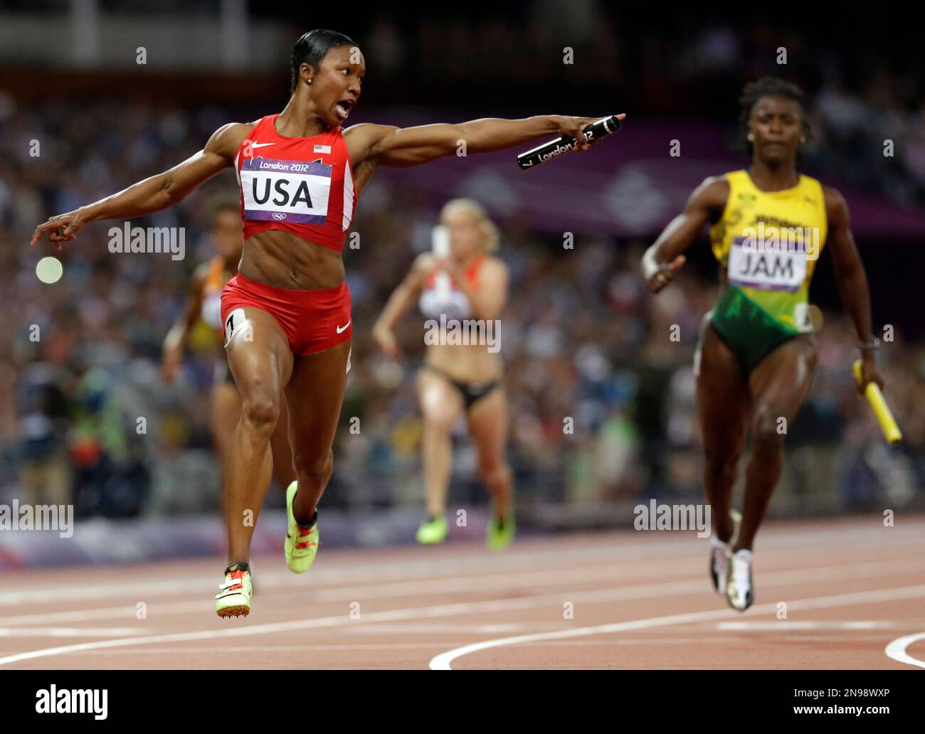 United States' Carmelita Jeter reacts as she crosses the finish line to ...