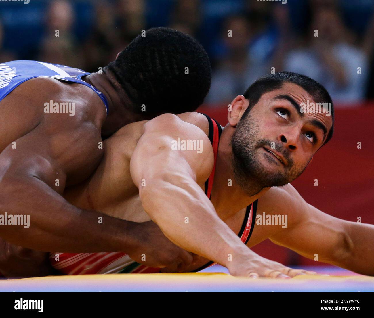 United States' Jordan Ernest Burroughs, in blue, competes against Iran ...
