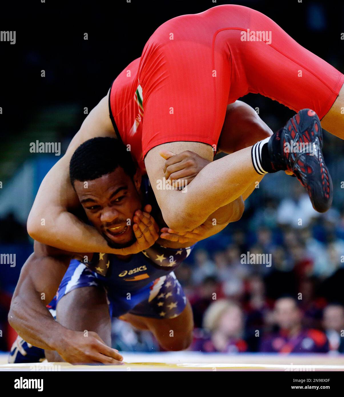 United States' Jordan Ernest Burroughs, in blue, competes against Iran ...