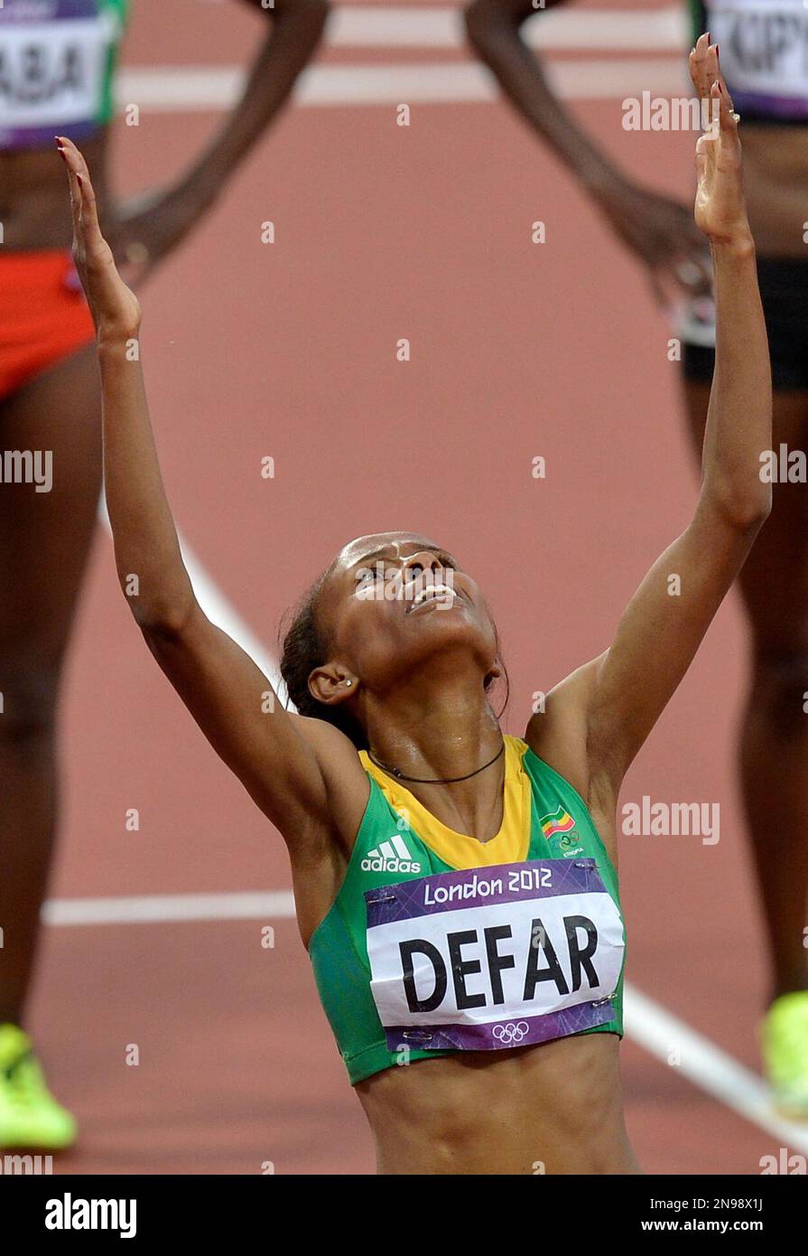 Ethiopia's Meseret Defar reacts as she crosses the finish line to win ...