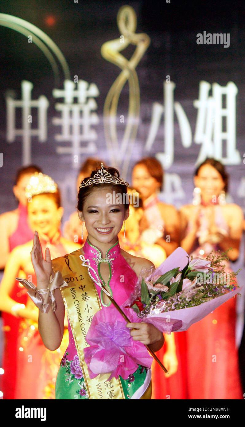 Elecher Lee of Malaysia waves after winning the Miss Chinese Cosmos Pageant Southeast Asia 2012 ...