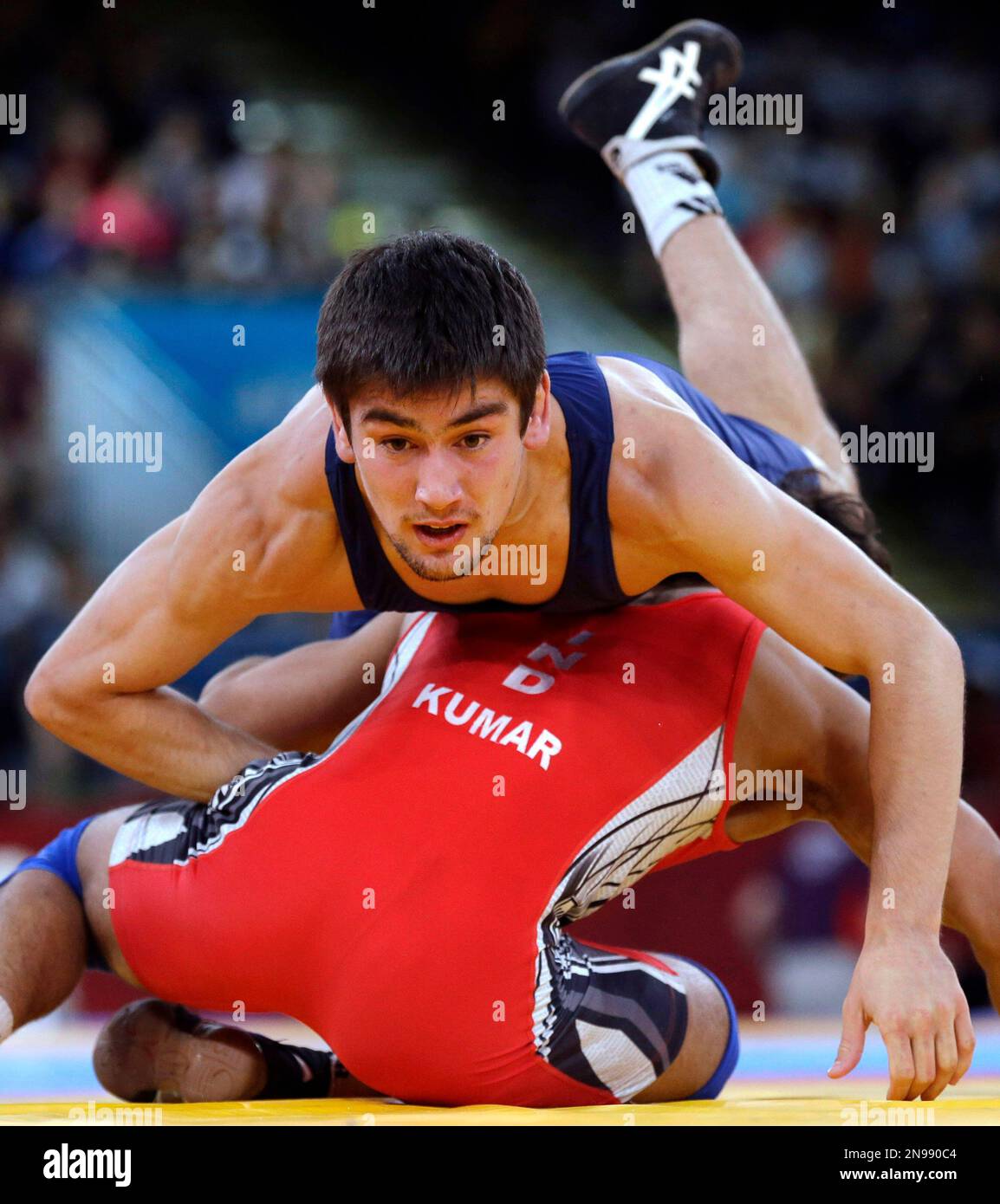 India's Amit Kumar, in red, and Georgia's Vladimer Khinchegashvili, in ...