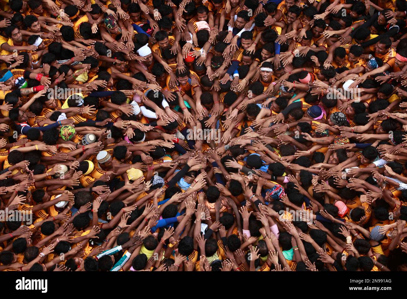 Devotees form a human pyramid to break the "Dahi handi," an earthen pot ...
