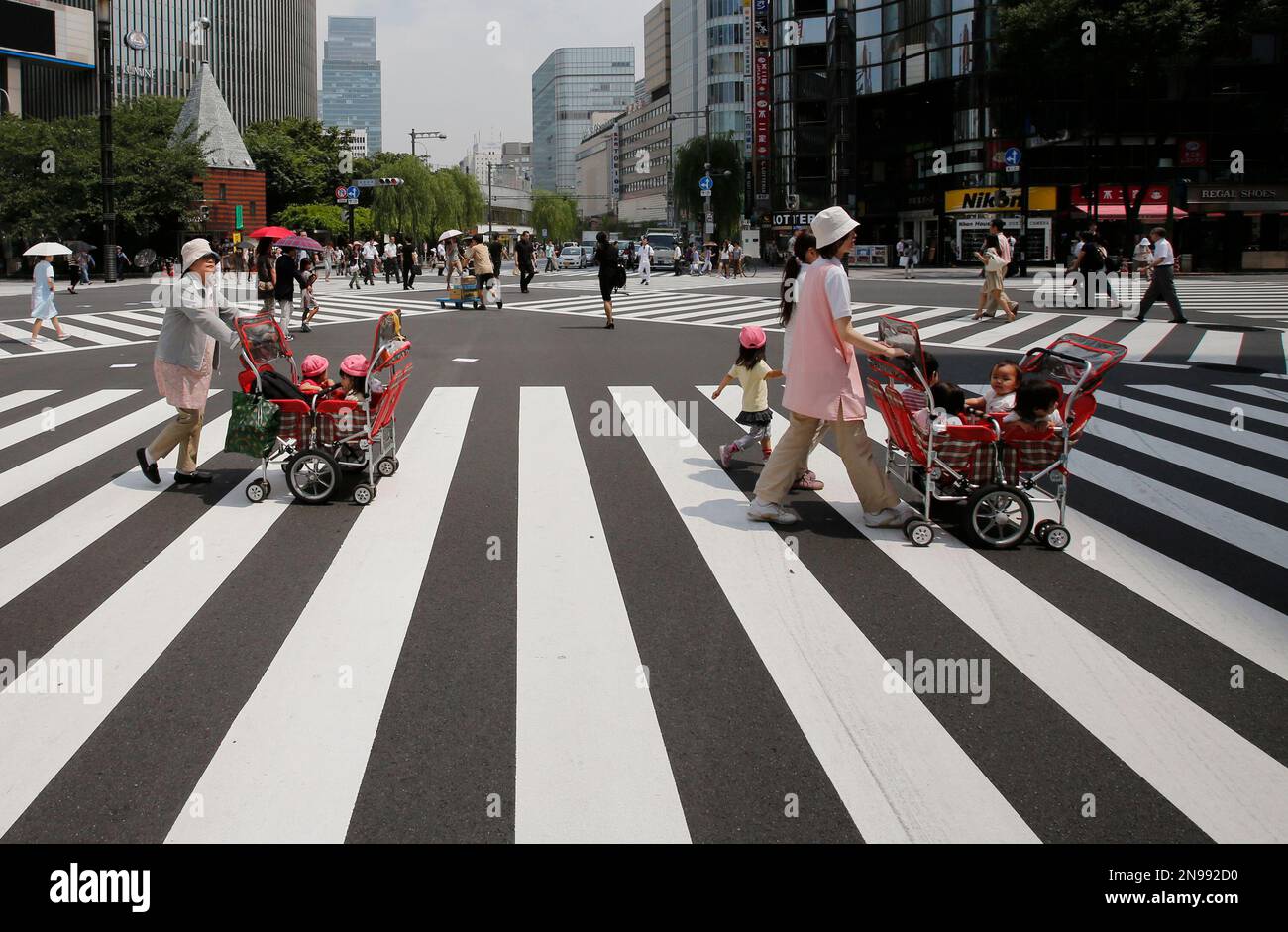 Teachers push carts with kindergarten children on board in Tokyo ...
