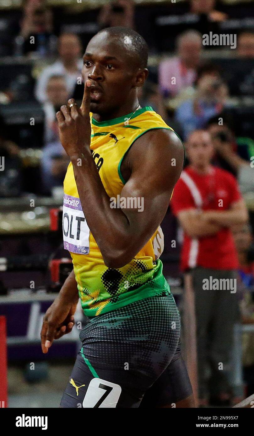 Jamaica's Usain Bolt reacts as he crosses the finish line in the men's ...