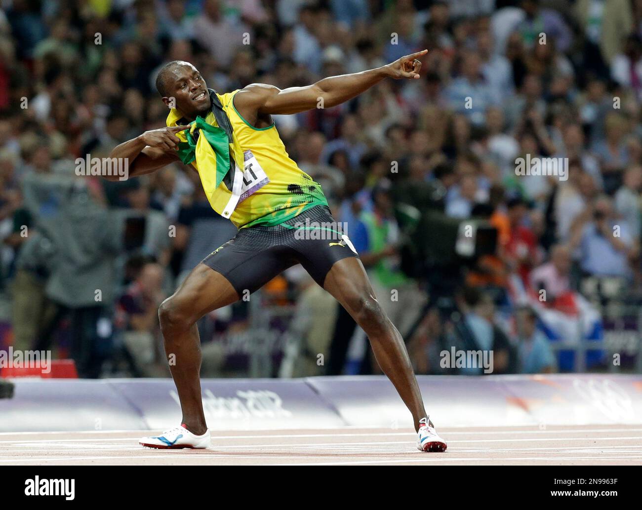 Jamaica's Usain Bolt celebrates winning gold in the men's 200-meter ...